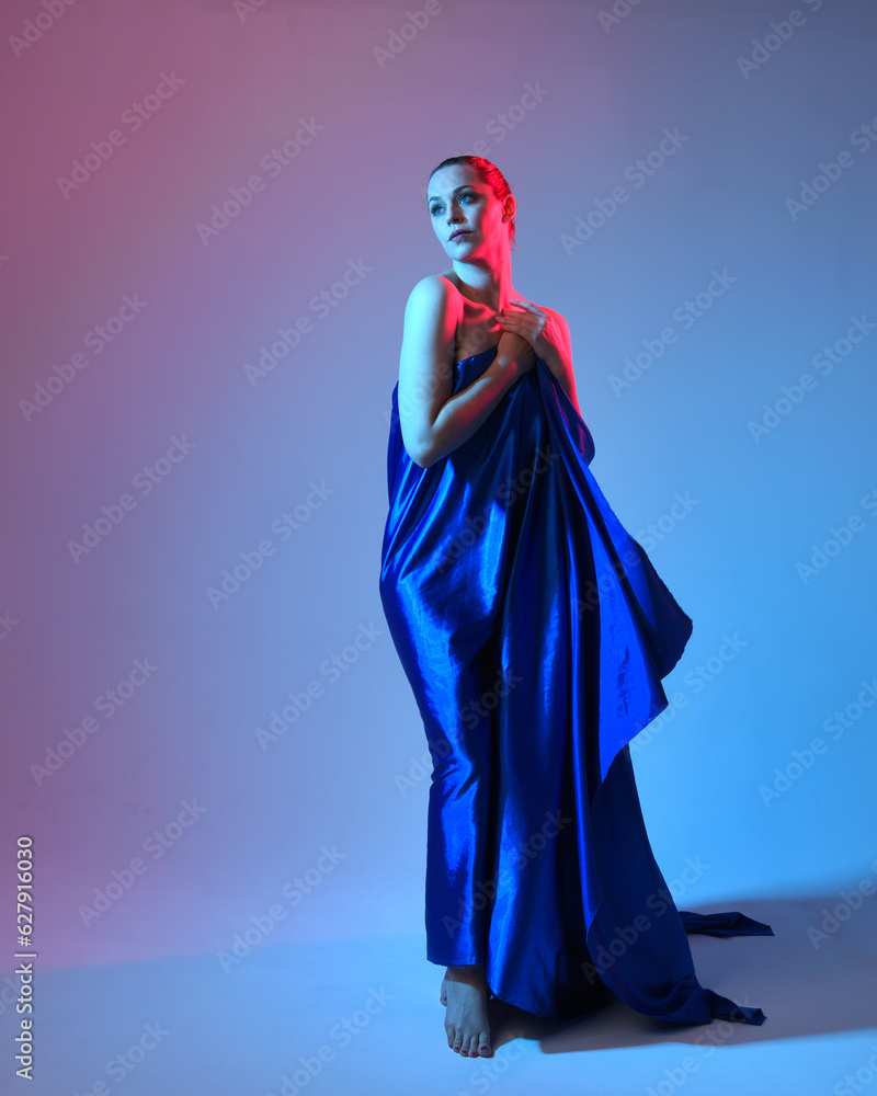 Full length portrait of beautiful female model wearing elegant flowing ...