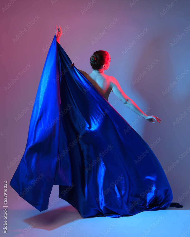Full length portrait of beautiful female model wearing elegant flowing ...