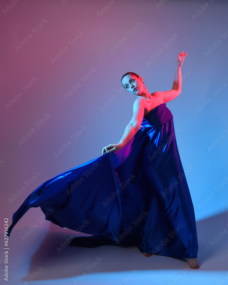 Full length portrait of beautiful female model wearing elegant flowing ...