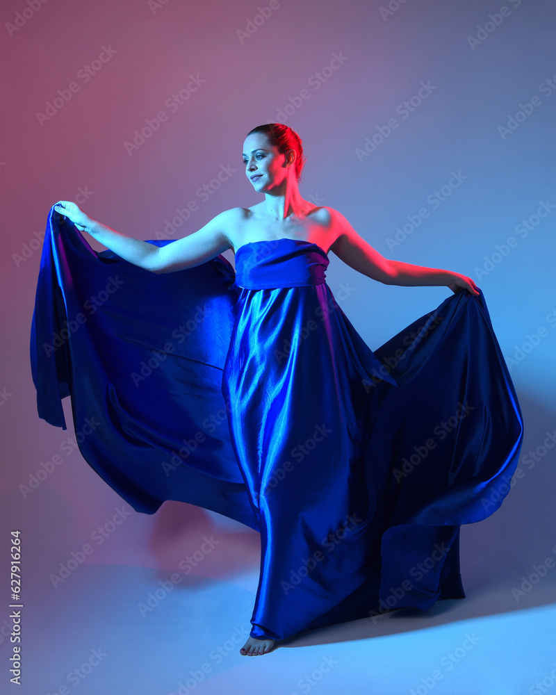 Full length portrait of beautiful female model wearing elegant flowing ...