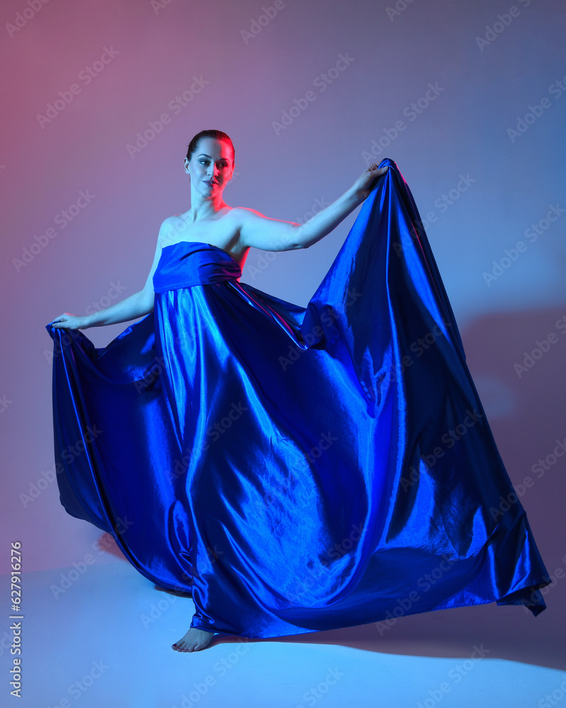 Full length portrait of beautiful female model wearing elegant flowing ...