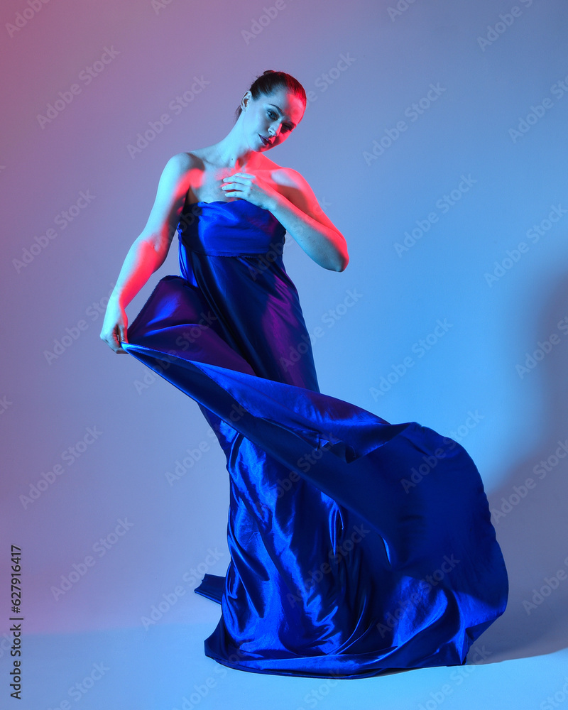 Full length portrait of beautiful female model wearing elegant flowing ...