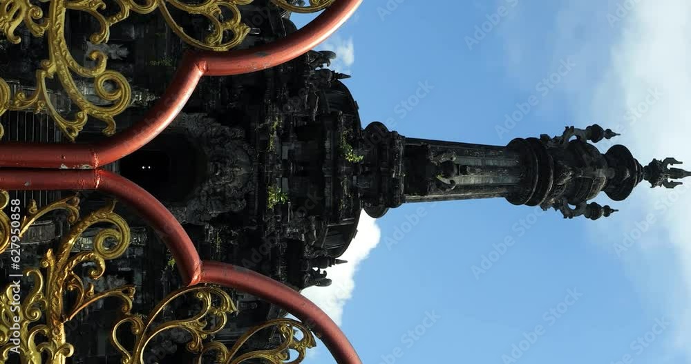 Vertical Tilt shot of a golden entrance gate opening to reveal the ...