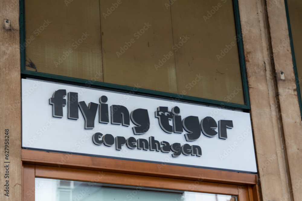 Flying Tiger Copenhagen logo brand and text sign front facade chain of ...