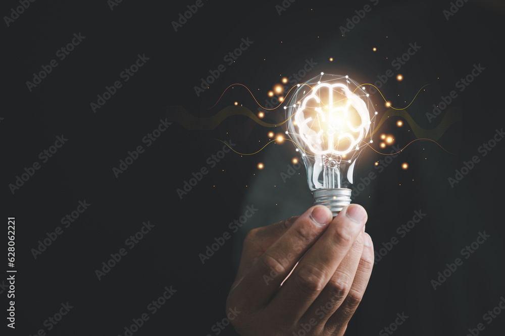 Hand holding light bulb, signifying the concept of innovative ideas and ...