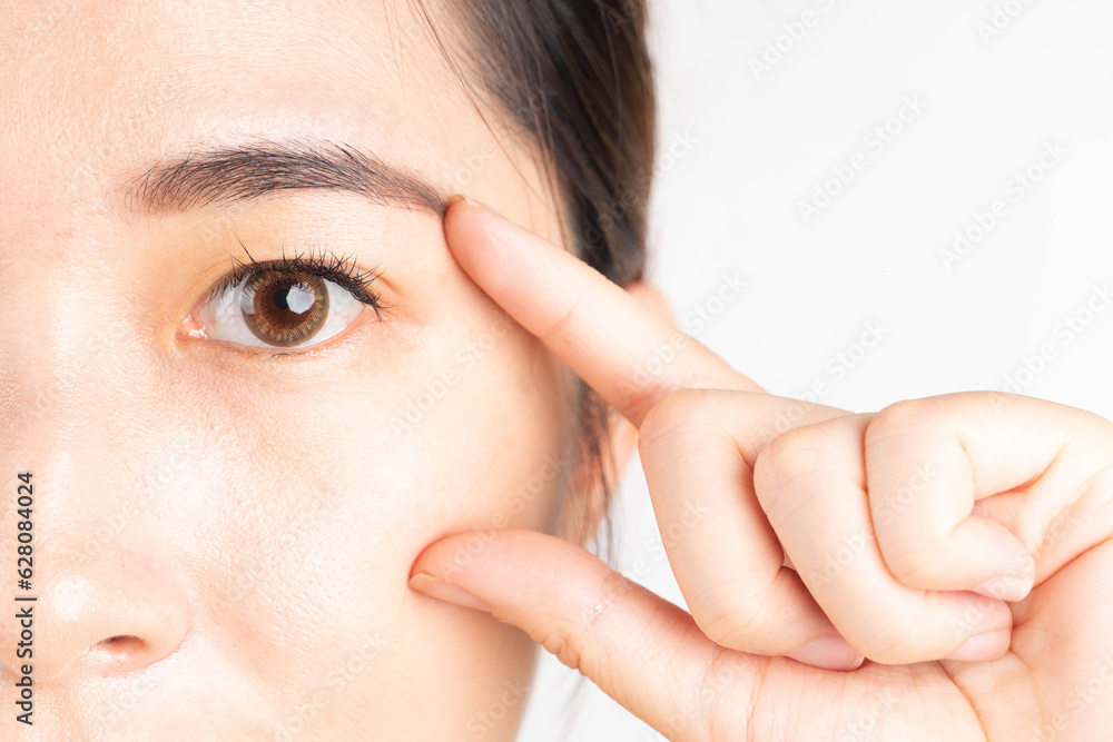 Beauty asian woman touching her healthy eyes over white background ...