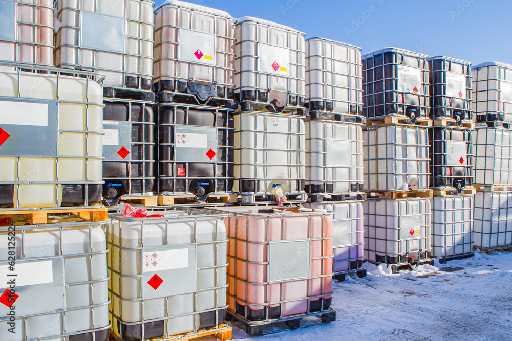 Plastic containers on flights. Square barrels for industrial products ...