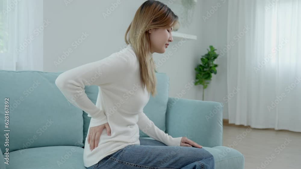 Asia beautiful woman holding her lower back while and suffer from ...