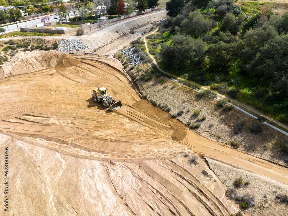 Heavy Equipment Cleaning Silt out of a Flood Control Catch Basin after ...