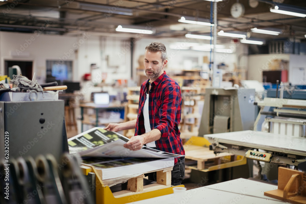 Man working in a printing press office Stock Photo | Adobe Stock