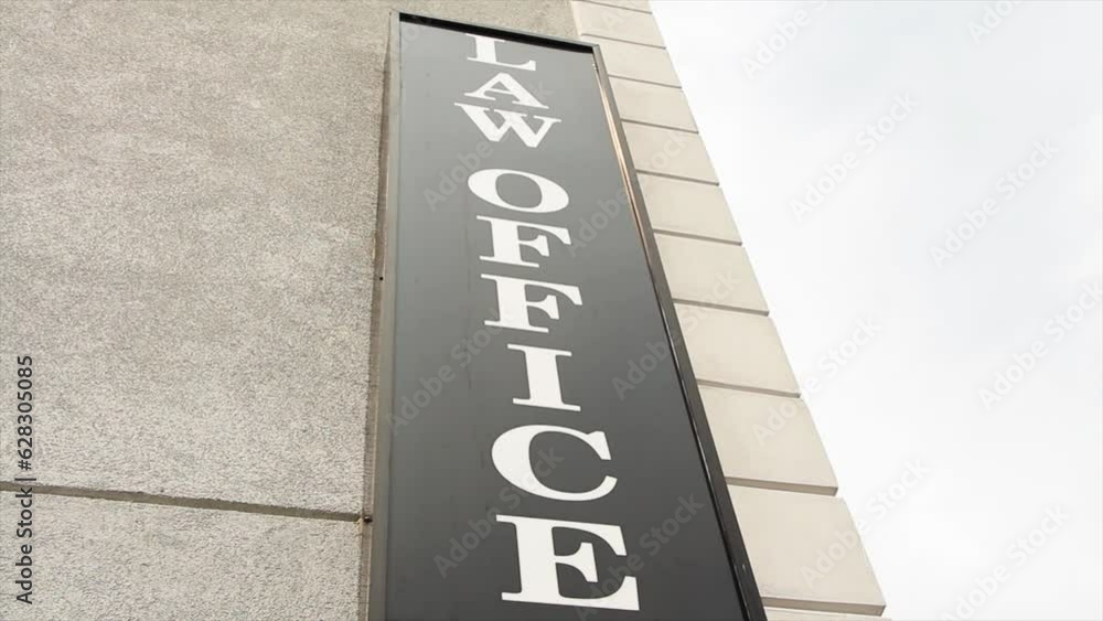 law office sign in white capital letter on black background on side of ...