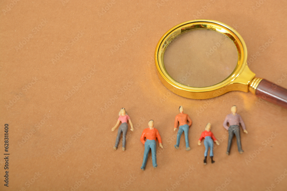 Magnifying glass and people figures.Finding hidden strengths: a ...