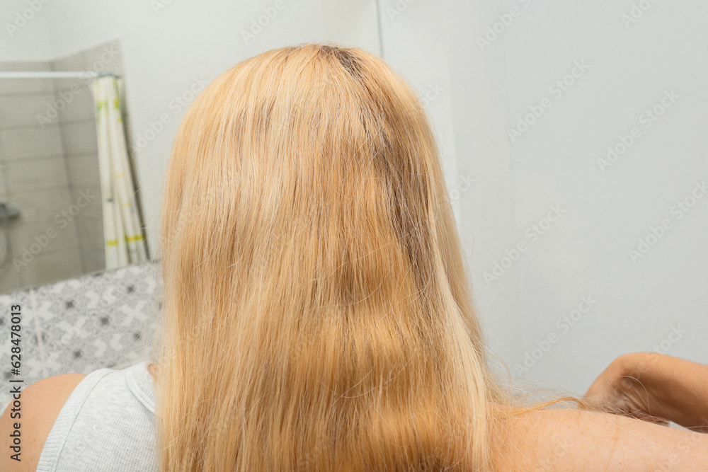 Blonde woman braiding her hair, close up photo. Hair Braid. Rear view ...