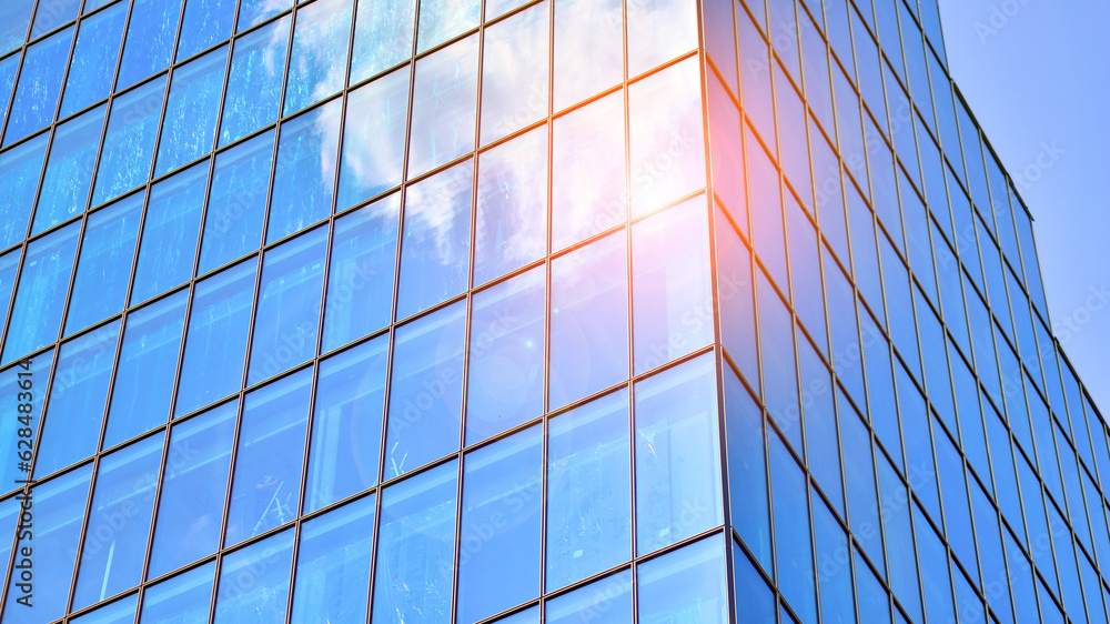 Structural glass wall reflecting blue sky. Abstract modern architecture ...