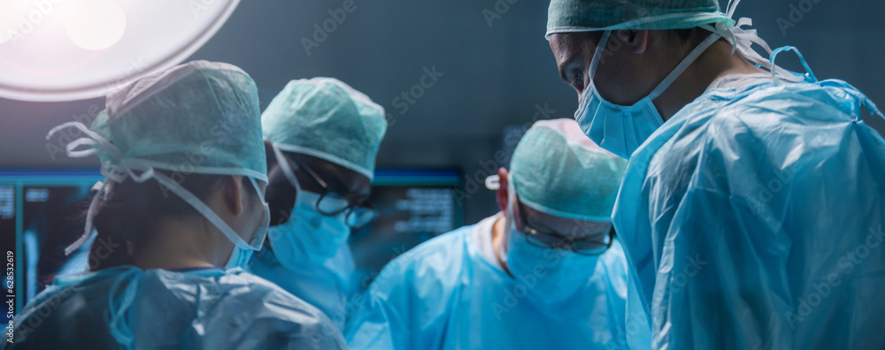 Photo Team of medical doctors performs surgical operation in modern ...