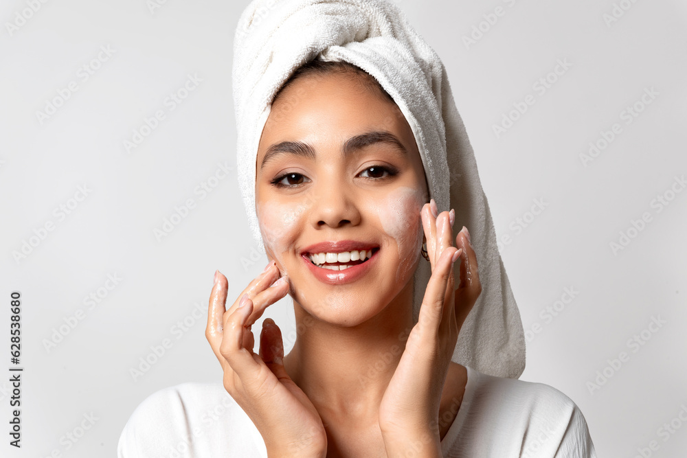 Smiling woman washing foam face by natural foamy gel. Girl applying ...