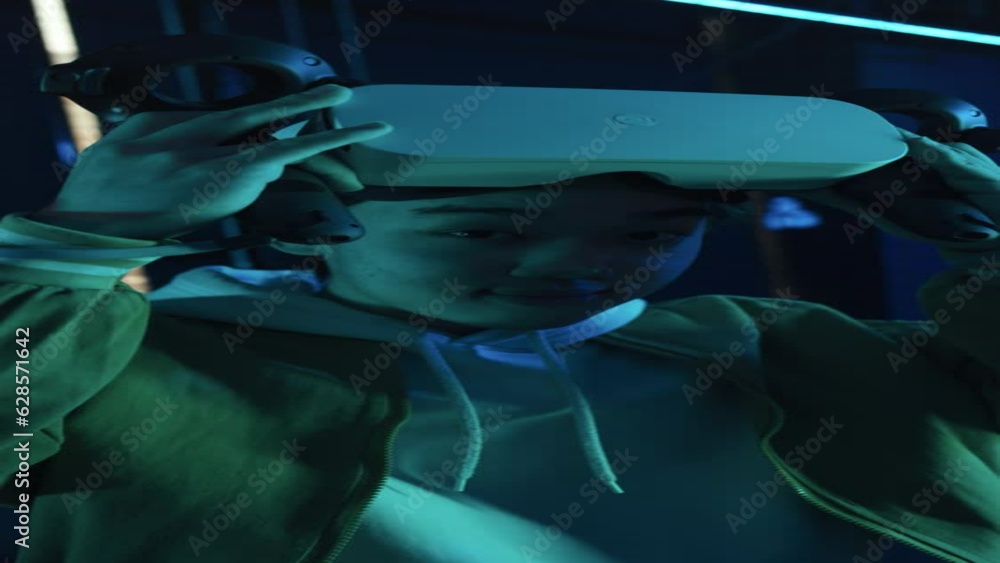 Medium close-up vertical portrait shot of young Chinese male gamer ...