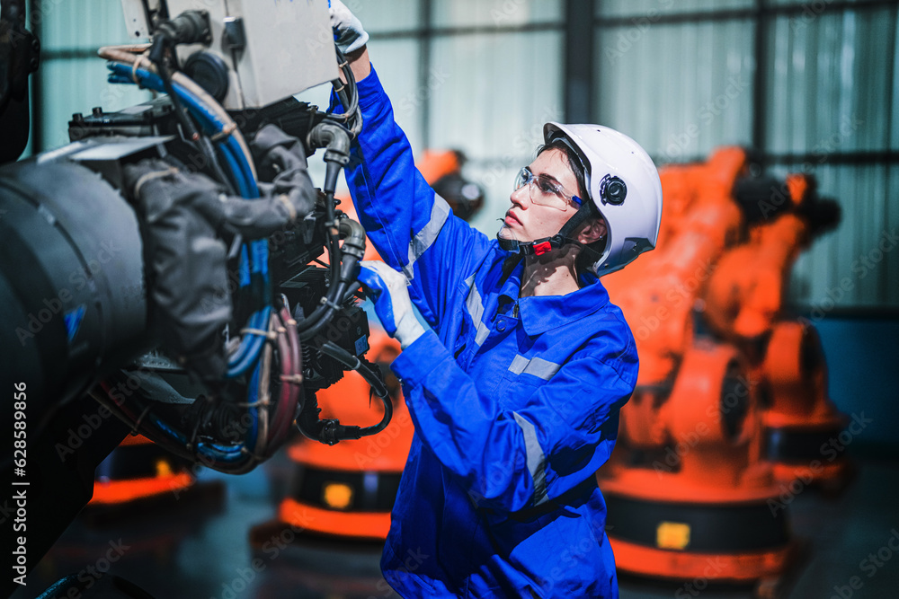 Factory engineer woman inspecting on machine with smart tablet. Worker ...