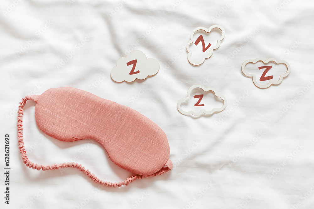 Above view pink sleep mask and clouds shapes with zzz snore sounds on ...