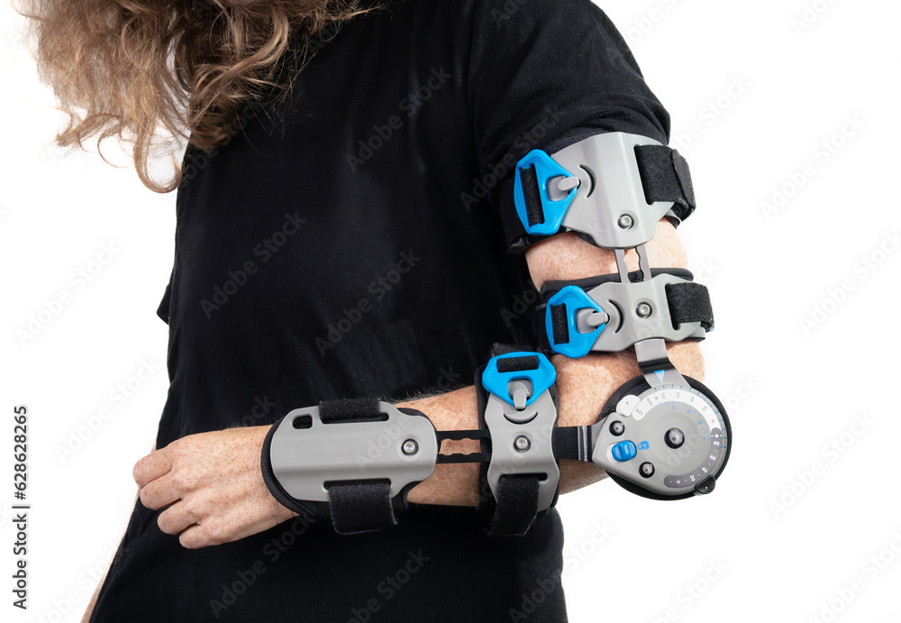 Woman with elbow brace or postoperative ROM brace. Medical device used ...