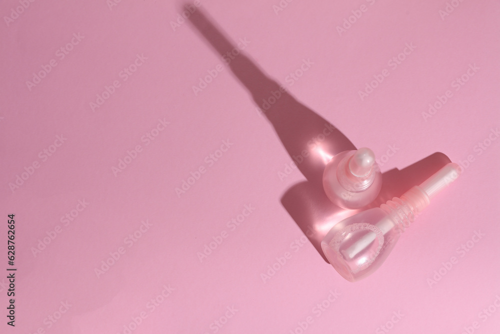 Vaginal enemas on pink background. Women's health. Top view with shadow ...