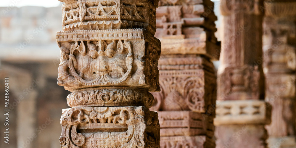 Stone columns with decorative bas relief of Qutb complex in South Delhi ...