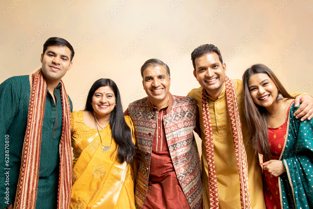 Happy indian family wearing traditional cloths standing isolated on ...