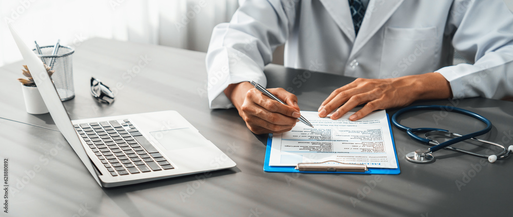 Doctor carefully review detailed medical report with laptop and ...