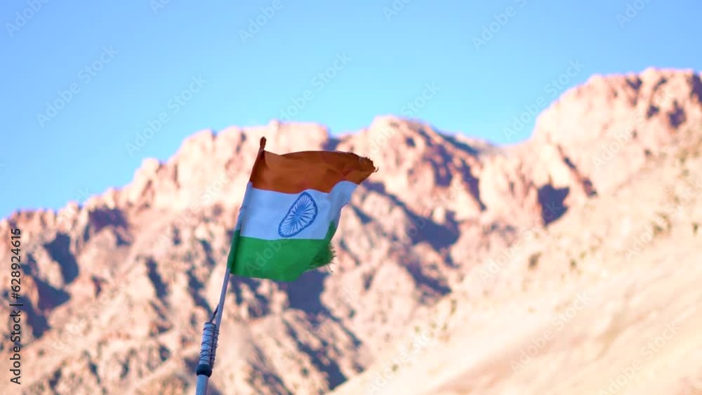 Indian flag waving in front of the Himalayan mountains in Padum town in ...