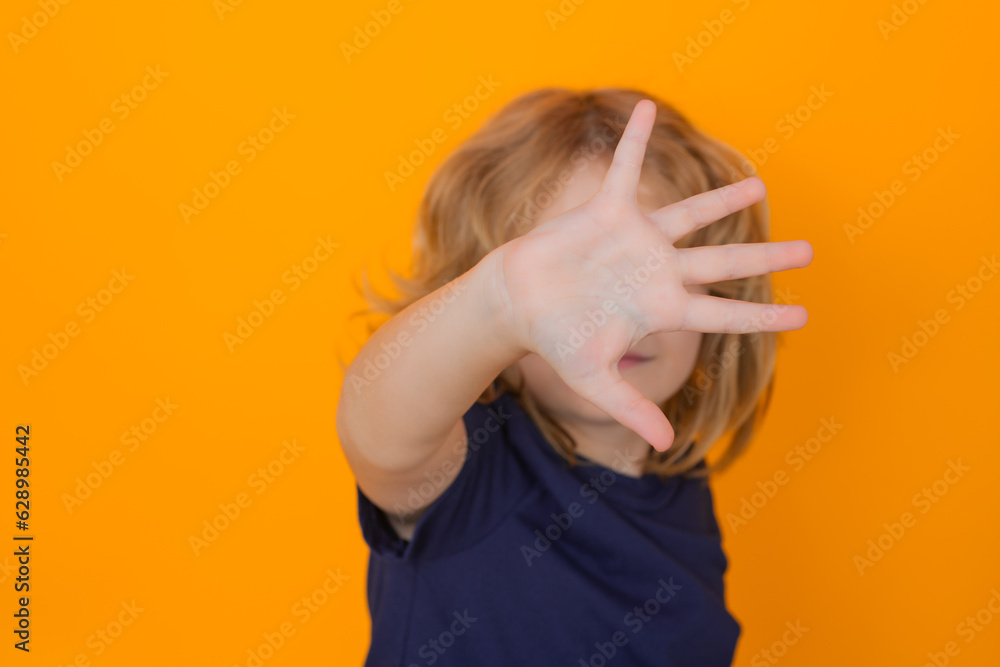 Kid making stop gesture on isolated studio background. Kid showing ...