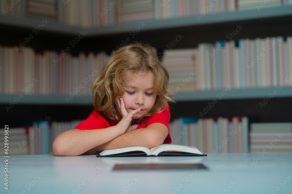 Thinking school kid. Schoolboy reading book in library. Kids ...