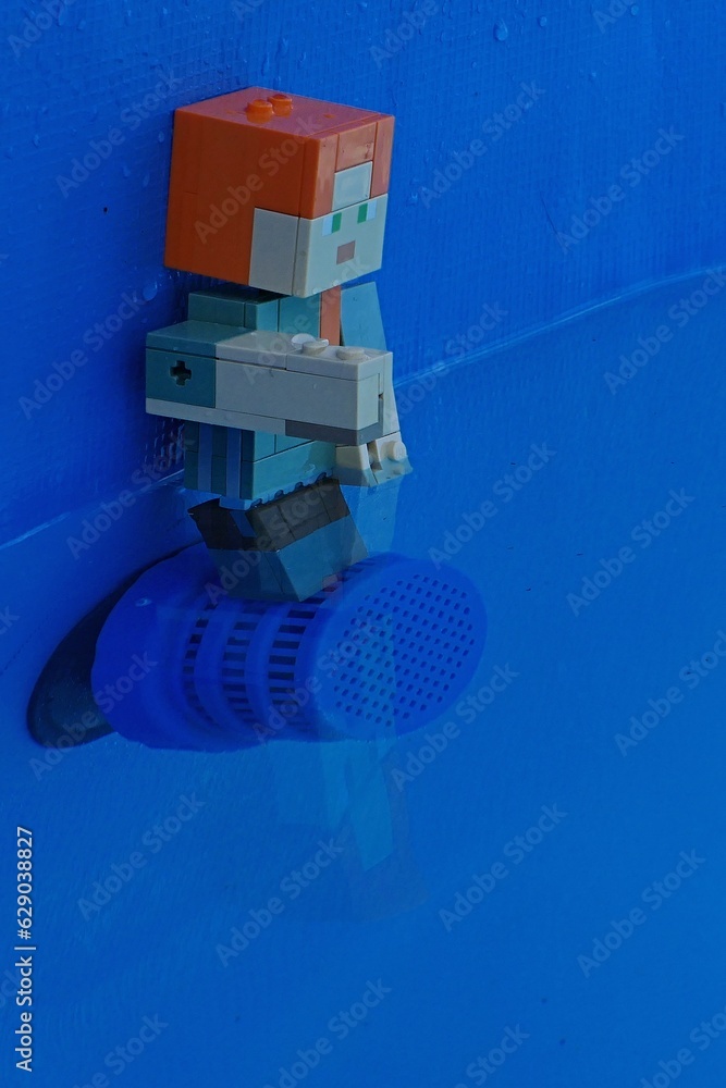 LEGO Minecraft figure of Alex standing on small round swimming pool ...