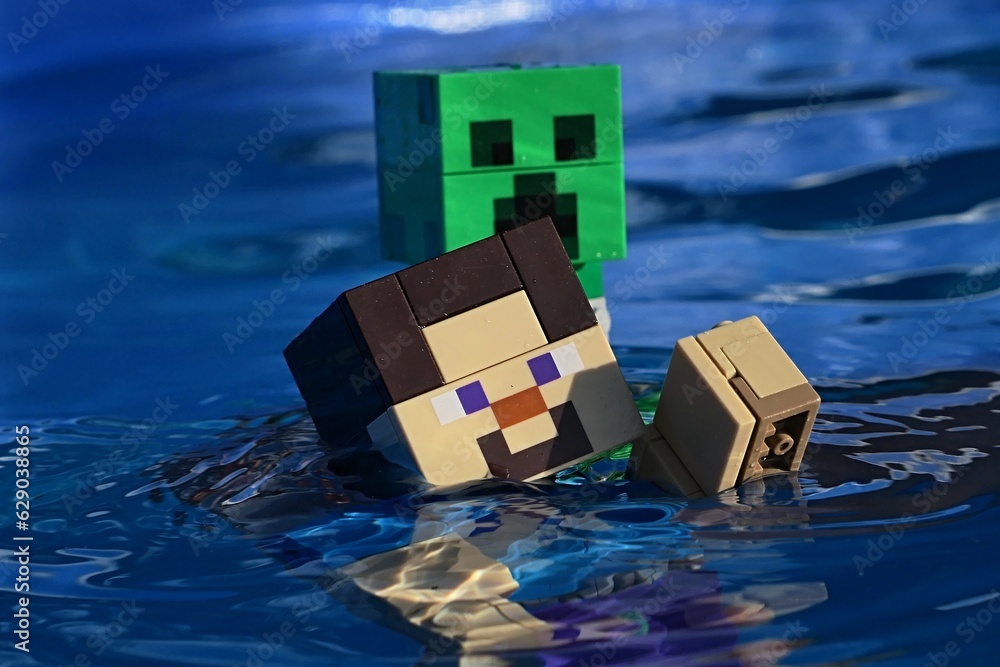 LEGO MInecraft figure of main character Steve with raised hand drowning ...
