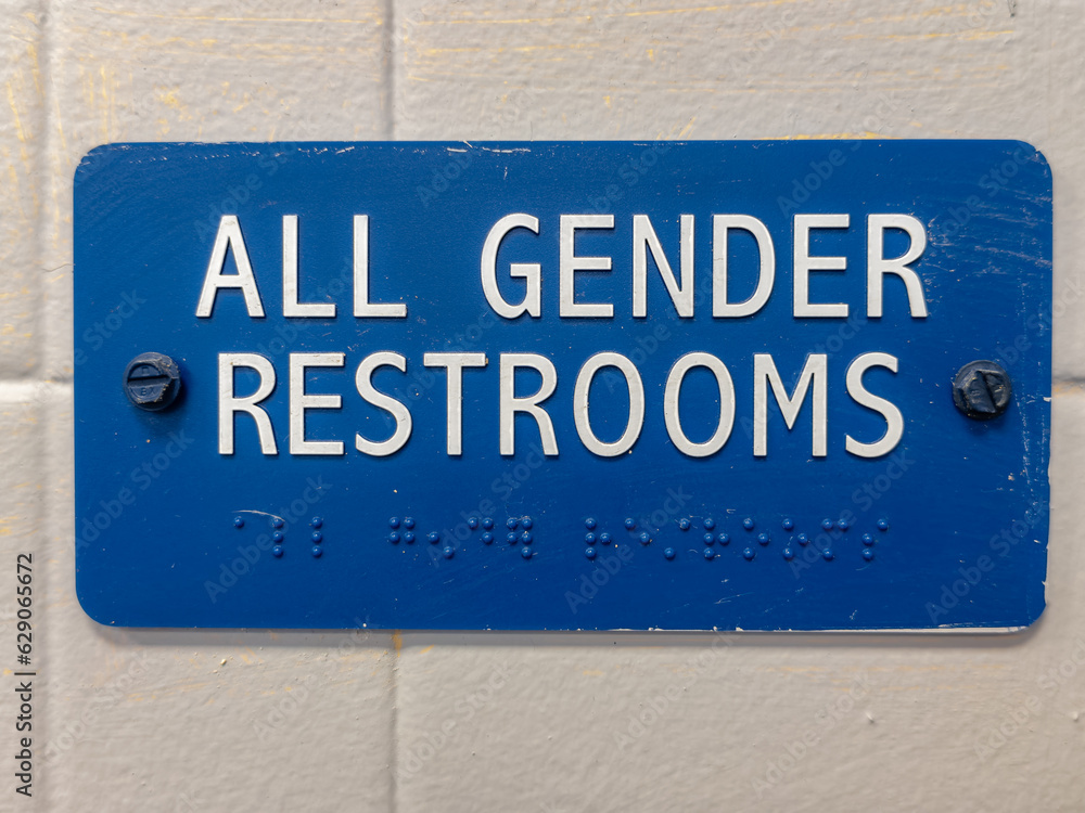 Blue all gender restroom sign with Braille code on the side of the ...