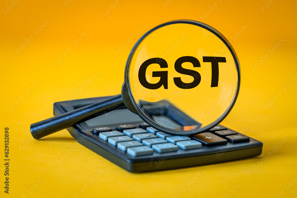 Black calculator and magnifying glass GST text, Beautiful yellow ...