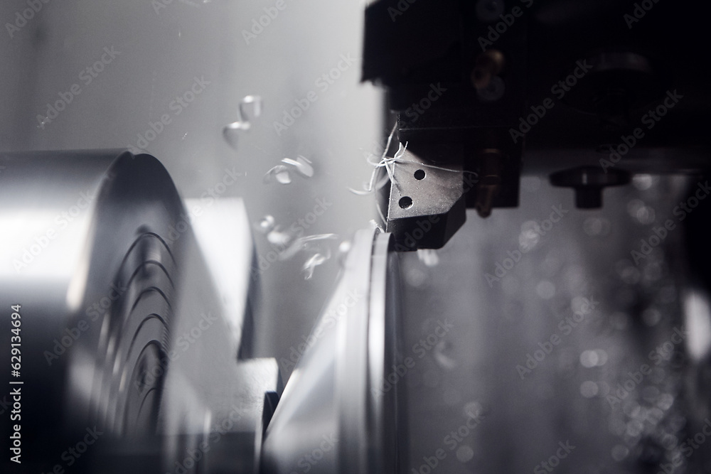 CNC lathe machine or turning machine cutting parts at the steel shaft ...