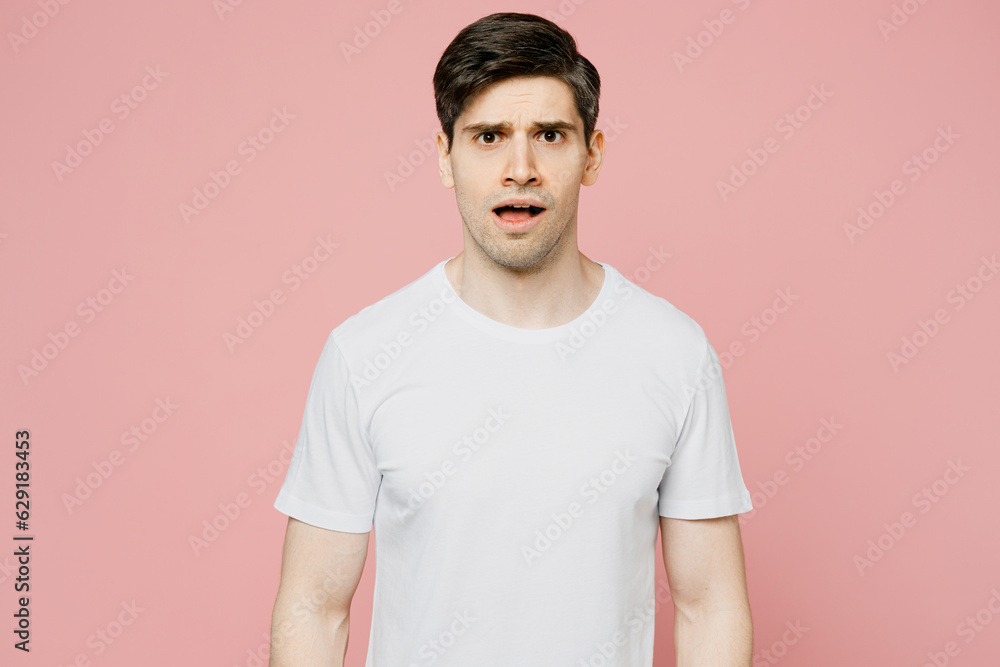 Young sad shocked stupefied scared caucasian man wearing white t-shirt ...