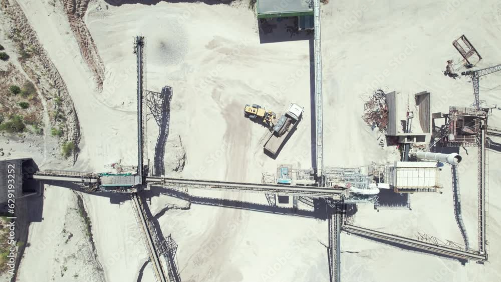 Front loader loading dumper truck with crushed stone. Stone crushing ...