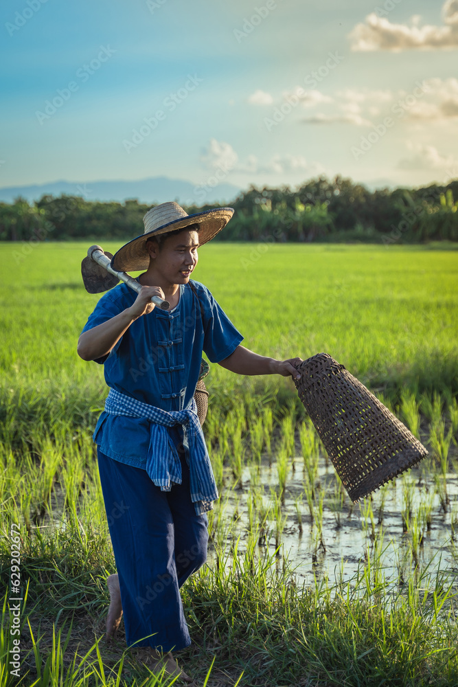 Handsome young man Asian Thai farmer in the countryside wearing Mohom ...