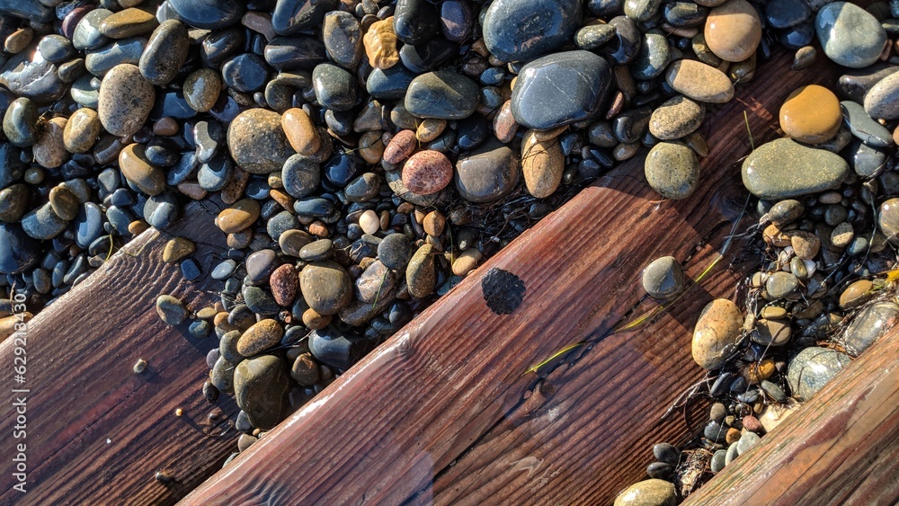 Cobble rock and redwood - A contrasting mix of hard granitic cobble ...