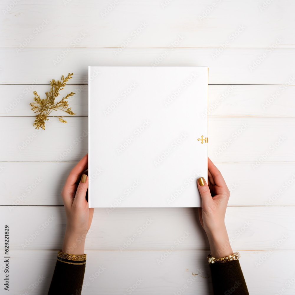 Hands holding a book, a box with a white cover on a white background ...