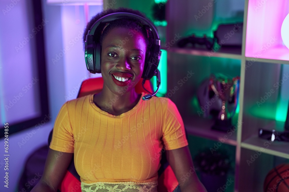 African american woman streamer smiling confident using headphones at ...