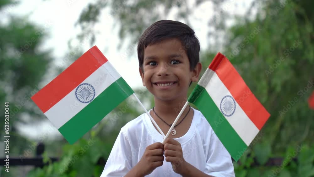 Portrait of a little cute boy with tricolour indian flag, boy to show ...