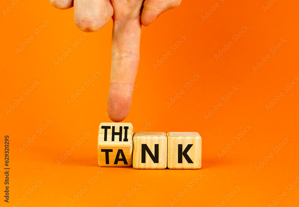 Think tank symbol. Businessman turns wooden cubes and changes the word ...