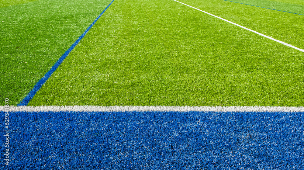 Beautiful Football field. White and blue lines on green artificial ...