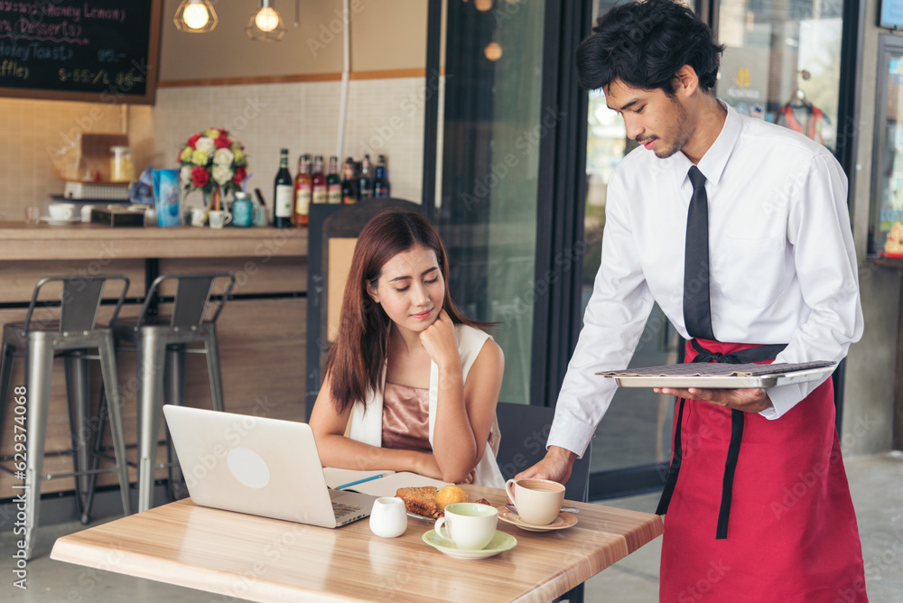 Restaurant business Handsome waiter serving food to young beautiful ...