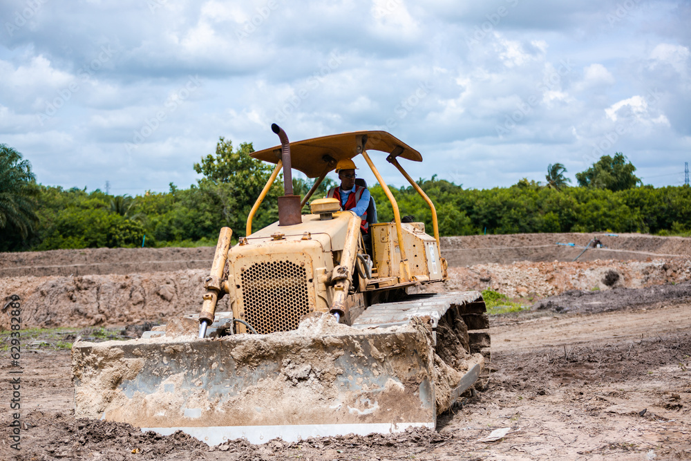 Black people worker in helmet on site construction, Excavator bulldozer ...