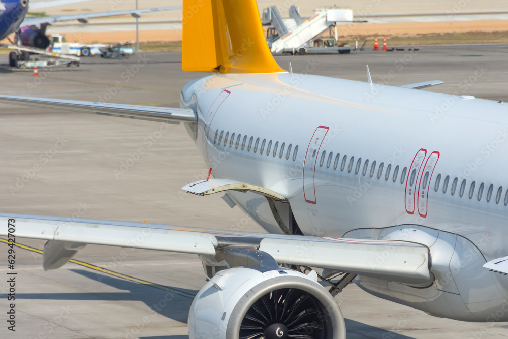 View of the engine of a passenger jet aircraft wing, open luggage cargo ...
