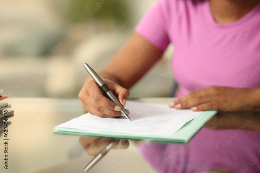 Black woman hand filling form on a desk Stock Photo | Adobe Stock