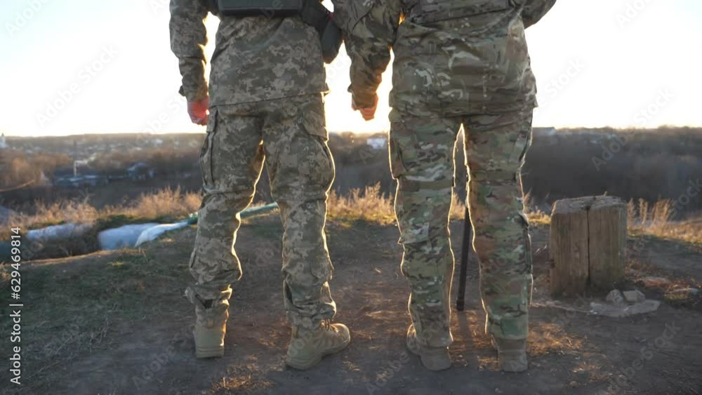 Military couple of ukrainian army holds hands of each other standing at ...